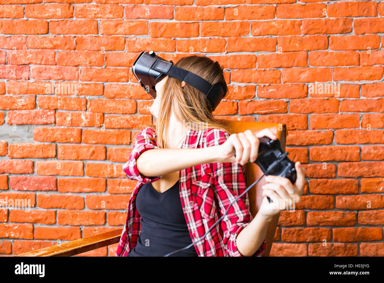 Woman play video game with joystick and VR device Stock Photo - Alamy
