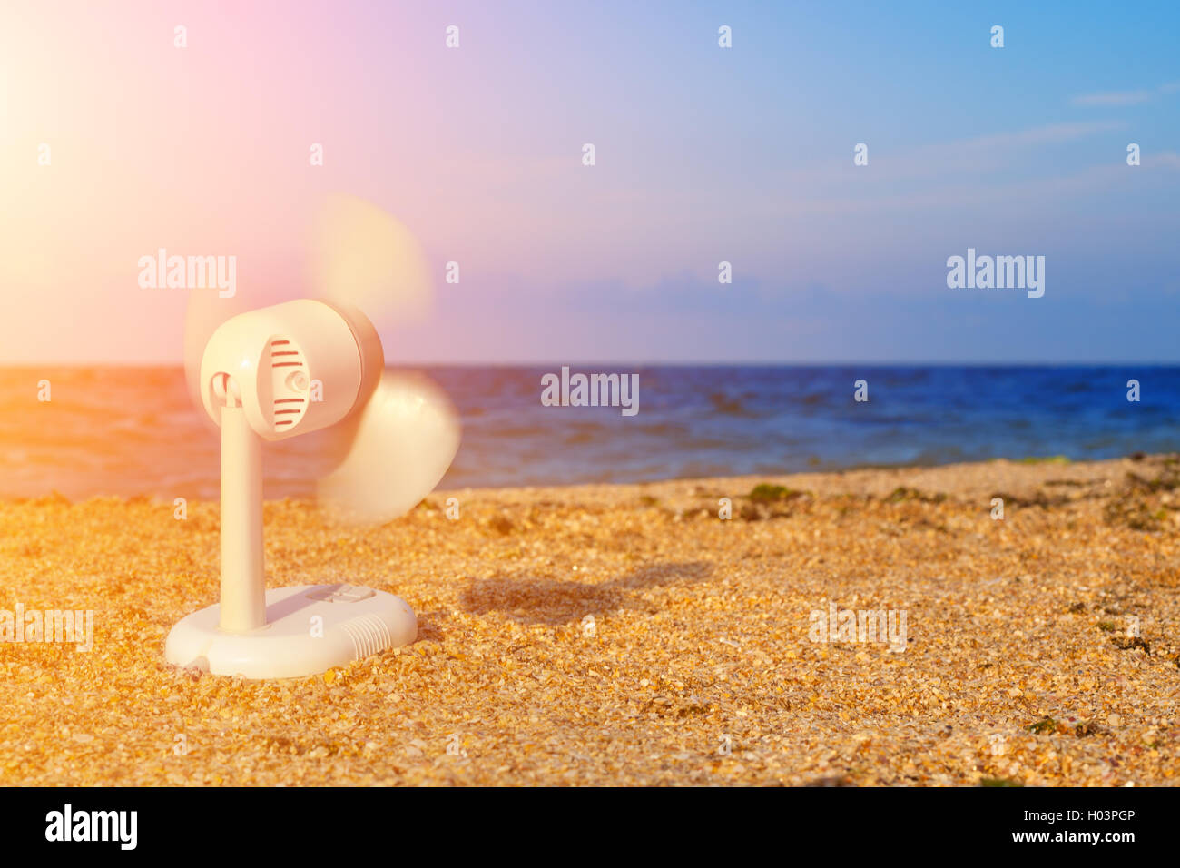 electric fan blowing on the beach in hot summer Stock Photo - Alamy