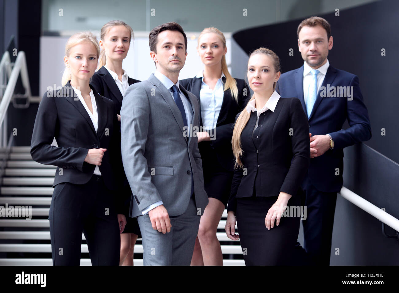Colleagues standing on stairs hi-res stock photography and images - Alamy