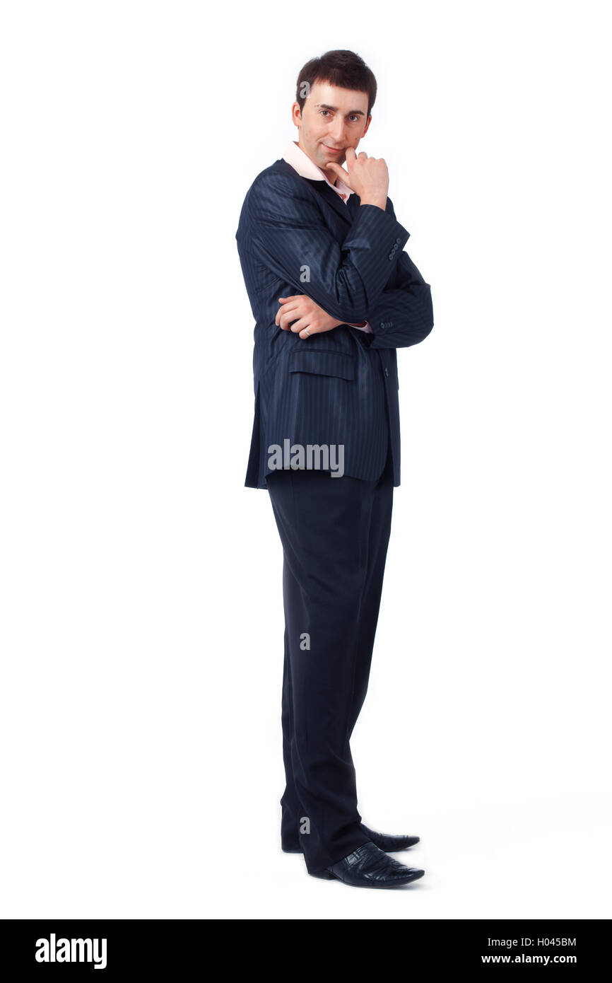 Young businessman is standing and thinking Stock Photo - Alamy