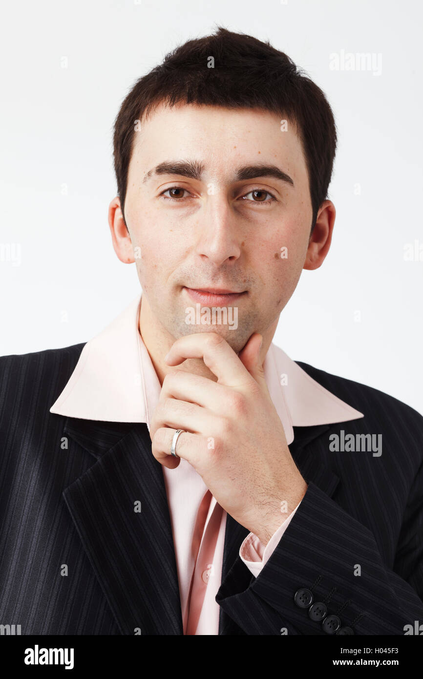 Portrait of smart young business man thinking and looking at you Stock ...