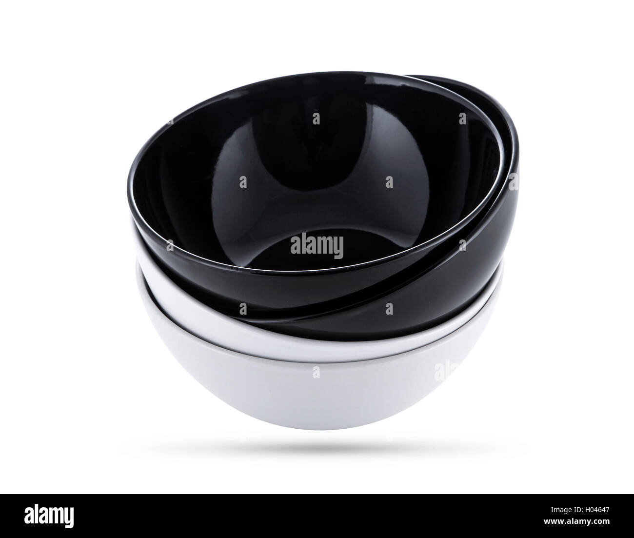 Stack of black and white bowls isolated Stock Photo - Alamy