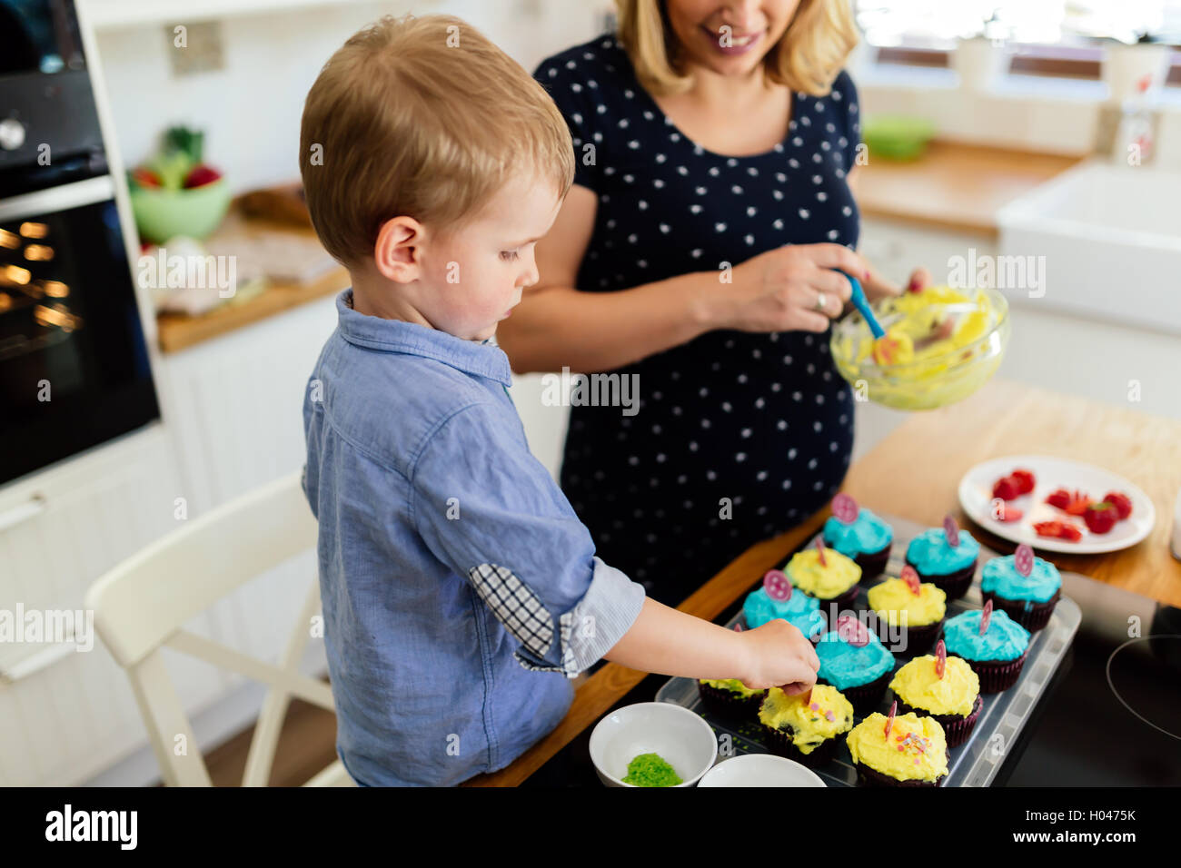Beautiful child and mother baking in kitchen with love Stock Photo - Alamy