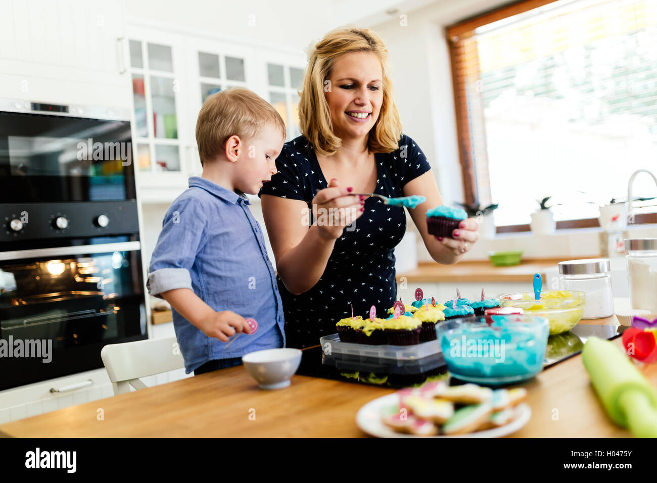 Beautiful child and mother baking in kitchen with love Stock Photo - Alamy