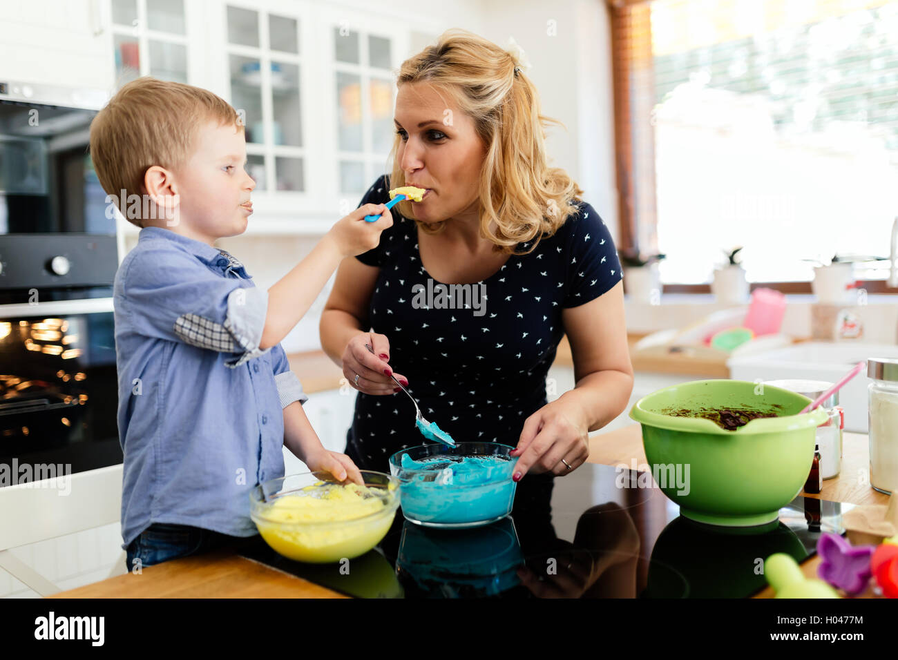 Cute child tasting cookie ingredients in kitchen Stock Photo - Alamy
