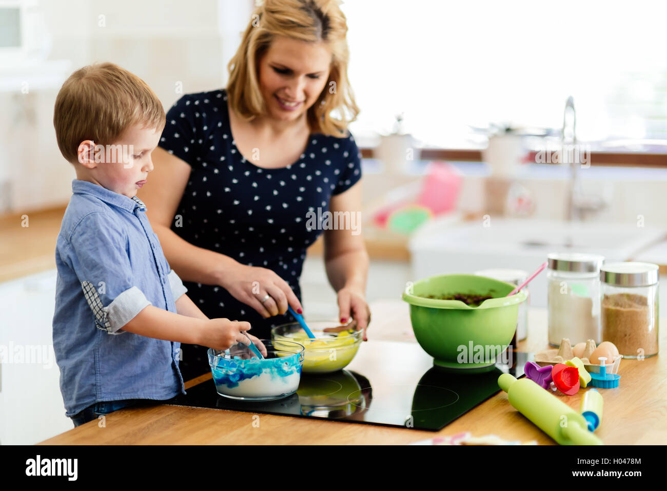 Beautiful child and mother baking in kitchen with love Stock Photo - Alamy