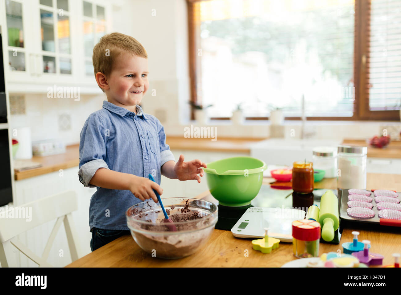 Adorable child below the age of 3 making cookies in kitchen Stock Photo ...