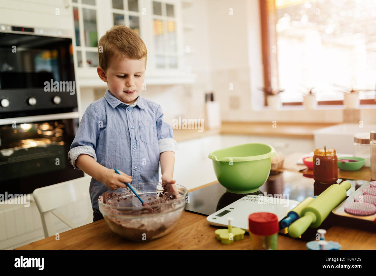 Cute child learning to become a chef since the age of 2 Stock Photo - Alamy
