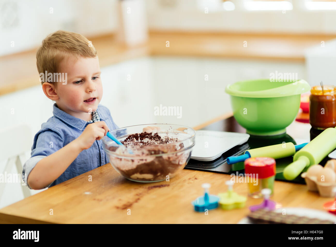 Adorable child below the age of 3 making cookies in kitchen Stock Photo ...