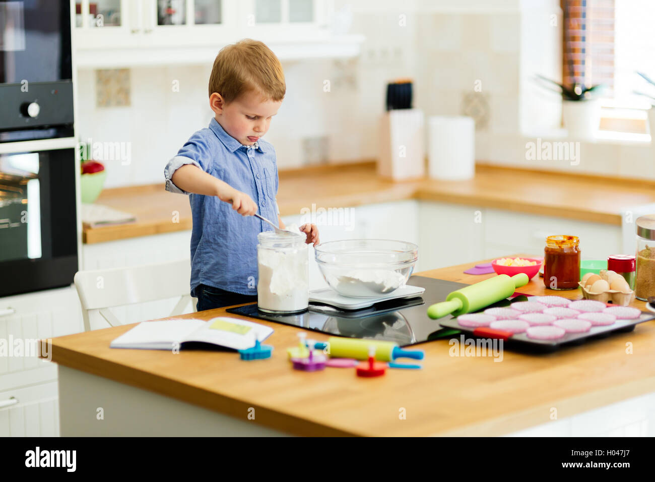 Cute child learning to become a chef since the age of 2 Stock Photo - Alamy