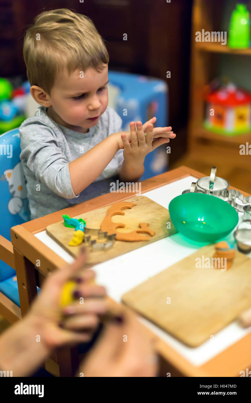 Little boy being creative with playdough Stock Photo - Alamy
