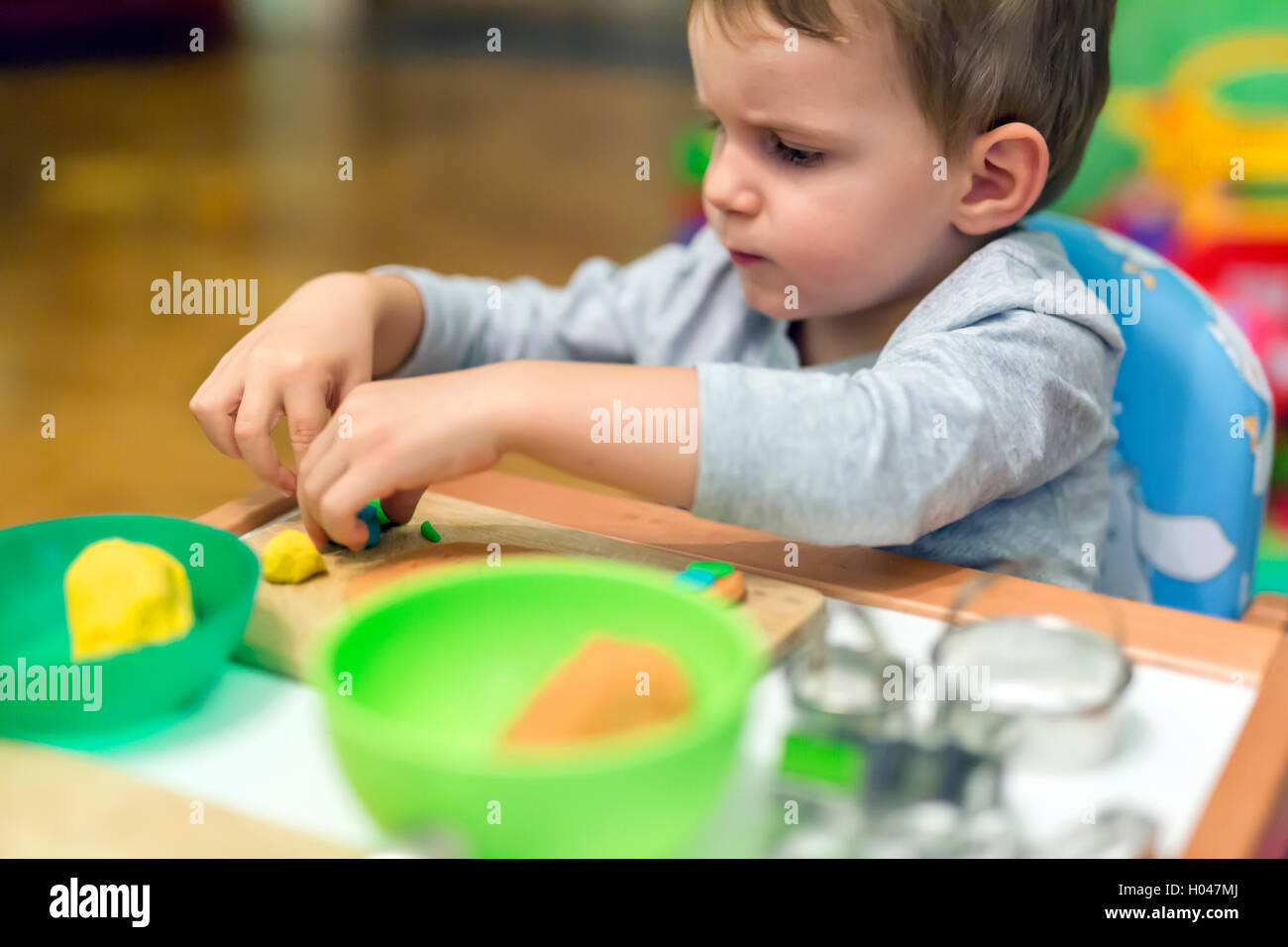 Little boy being creative with playdough Stock Photo - Alamy