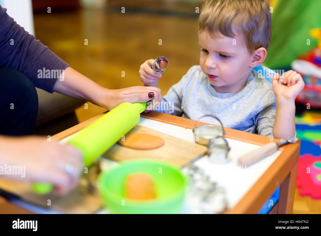 Little boy being creative with playdough Stock Photo - Alamy