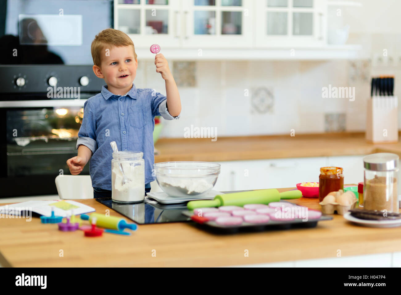 Adorable child below the age of 3 making cookies in kitchen Stock Photo ...