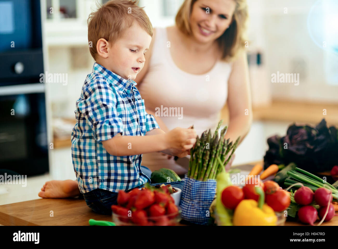 Mother and child preparing lunch in kitchen Stock Photo - Alamy