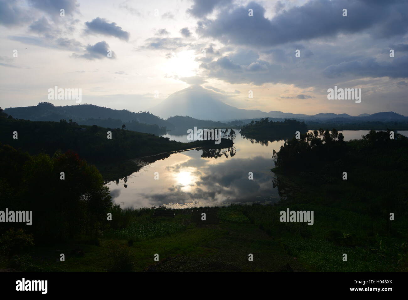 Late afternoon on a lake below the Virunga volcanoes Stock Photo - Alamy