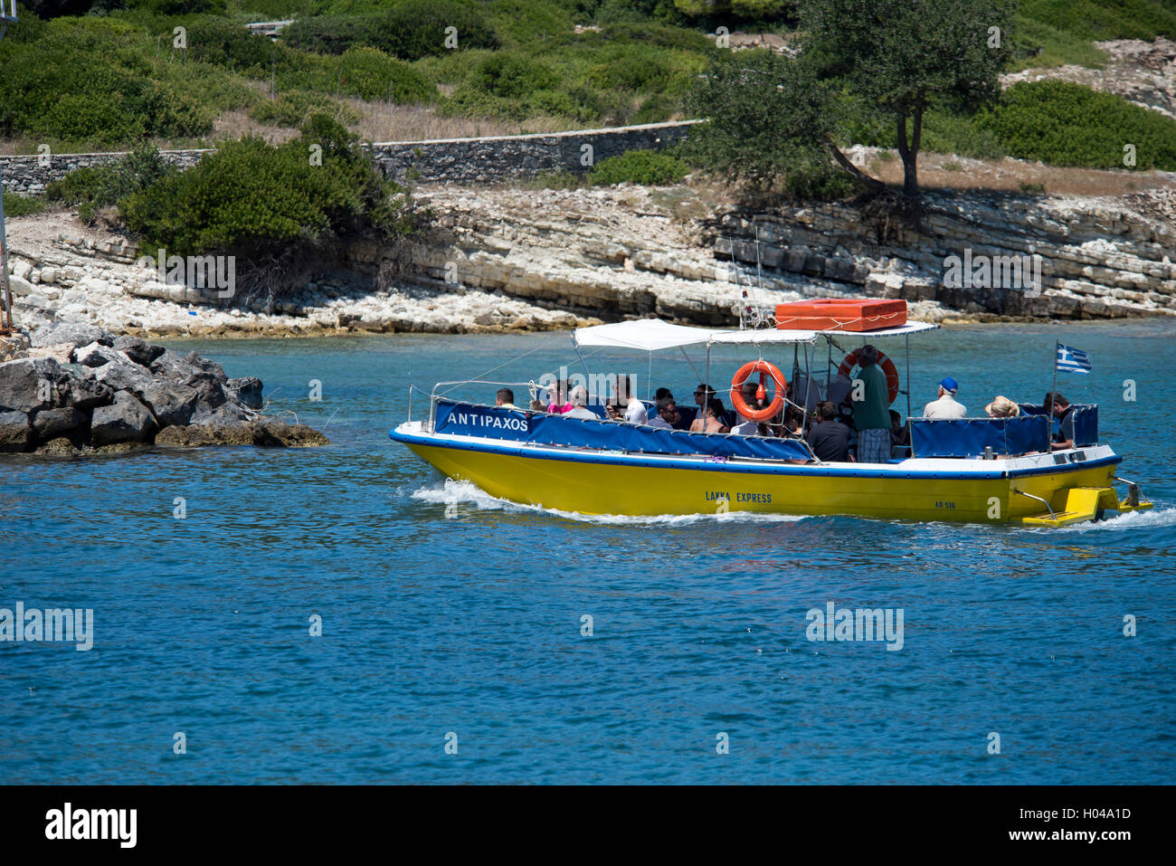 A small excursion boat full of tourists returning from Anti Paxos to ...