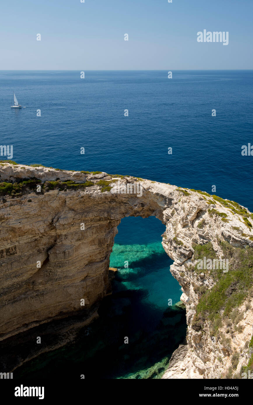 The Trypitos Arch, a limestone arch over the sea on Paxos, The Ionian ...