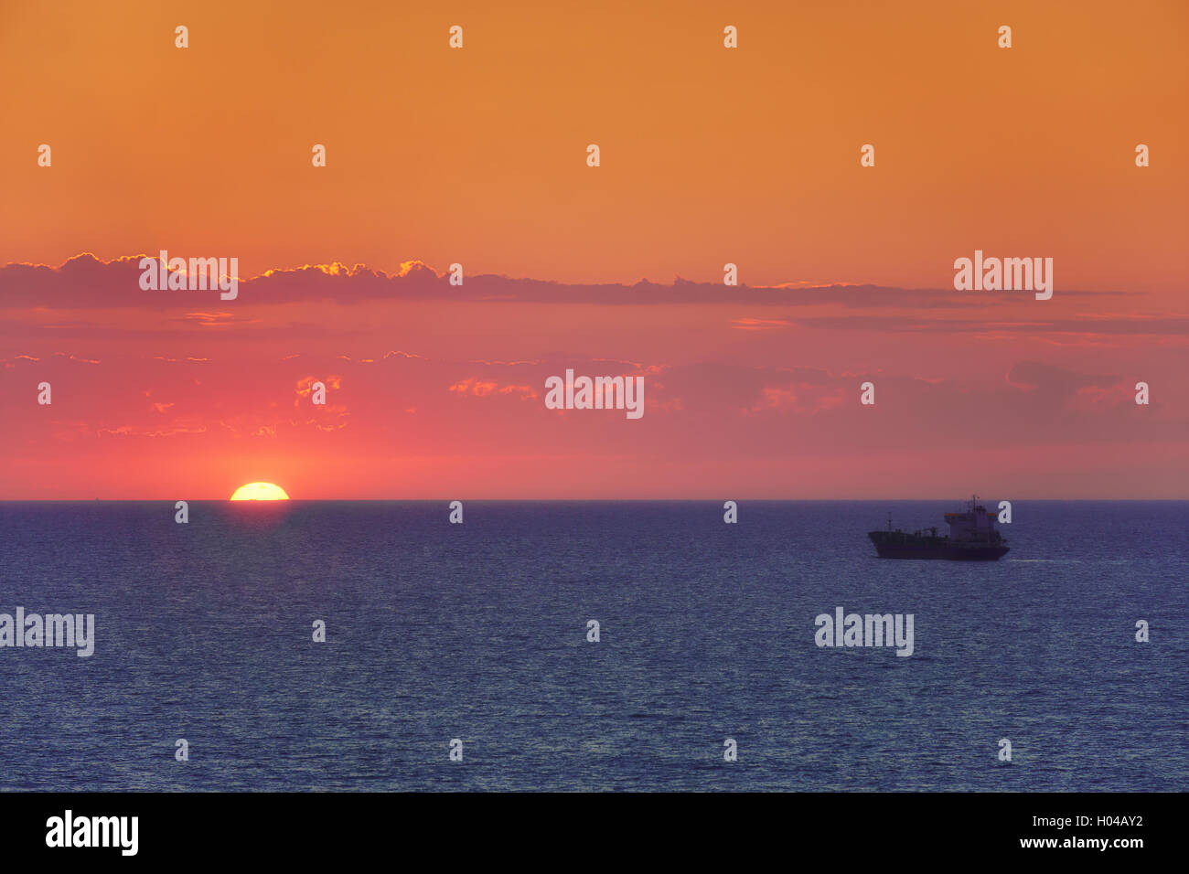 cargo ship at the sunset Stock Photo - Alamy
