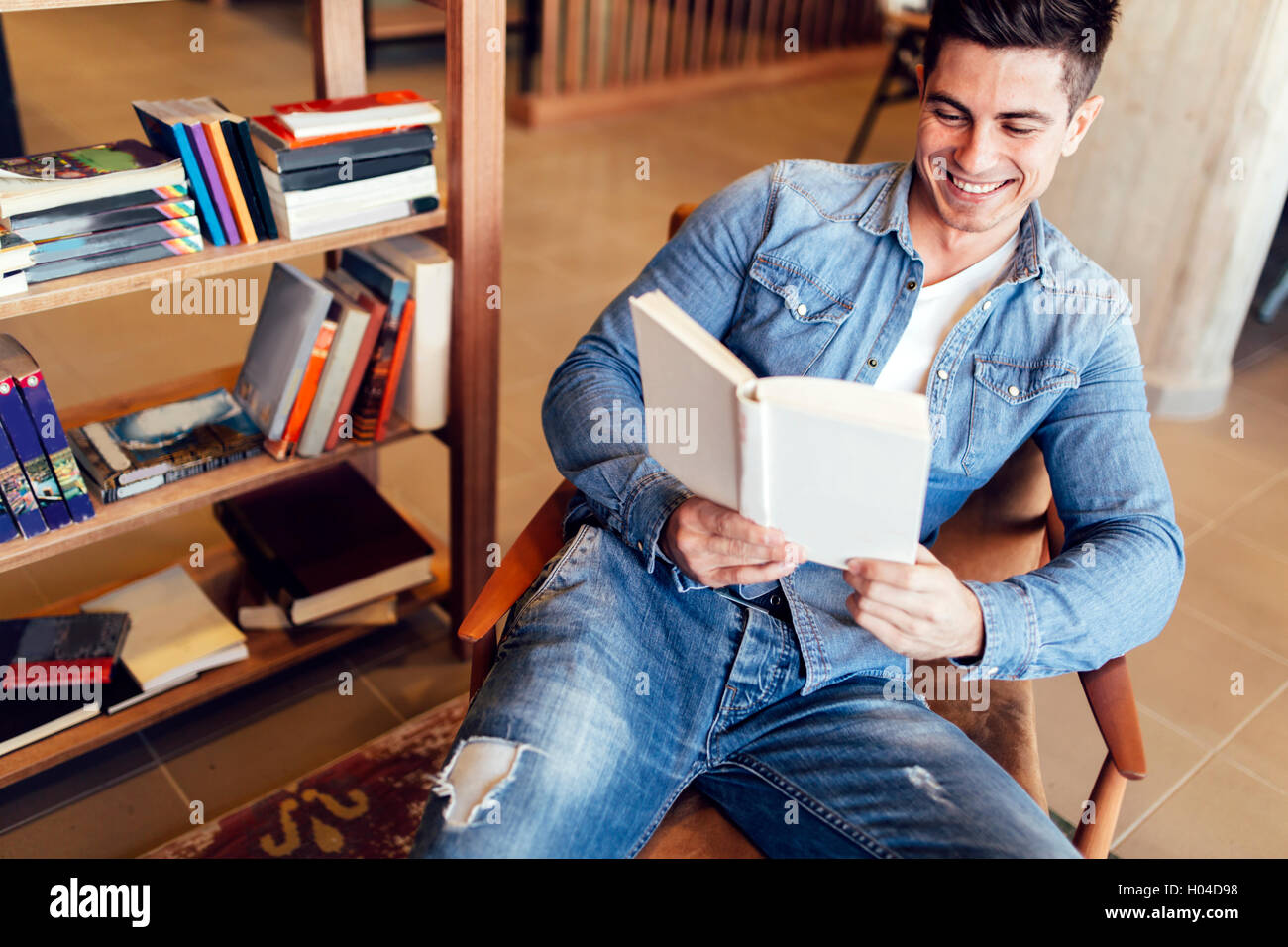 Handsome man studying by reading books and preparing for exam Stock ...