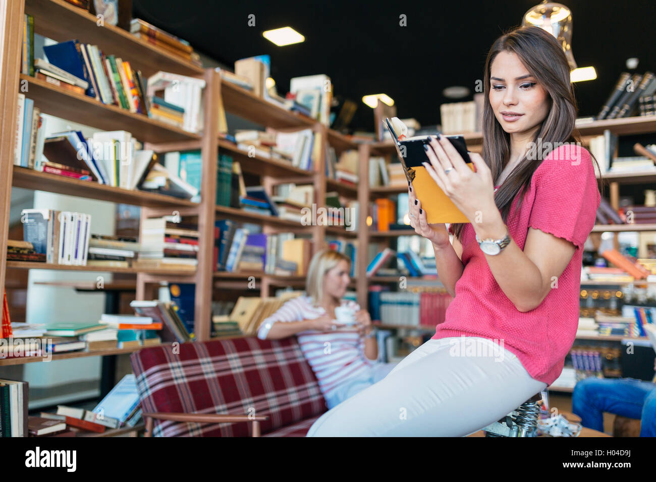 Intellectual students reading books in library Stock Photo - Alamy