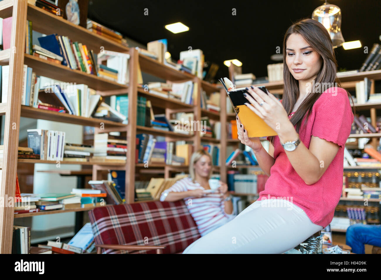 Intellectual students reading books in library Stock Photo - Alamy