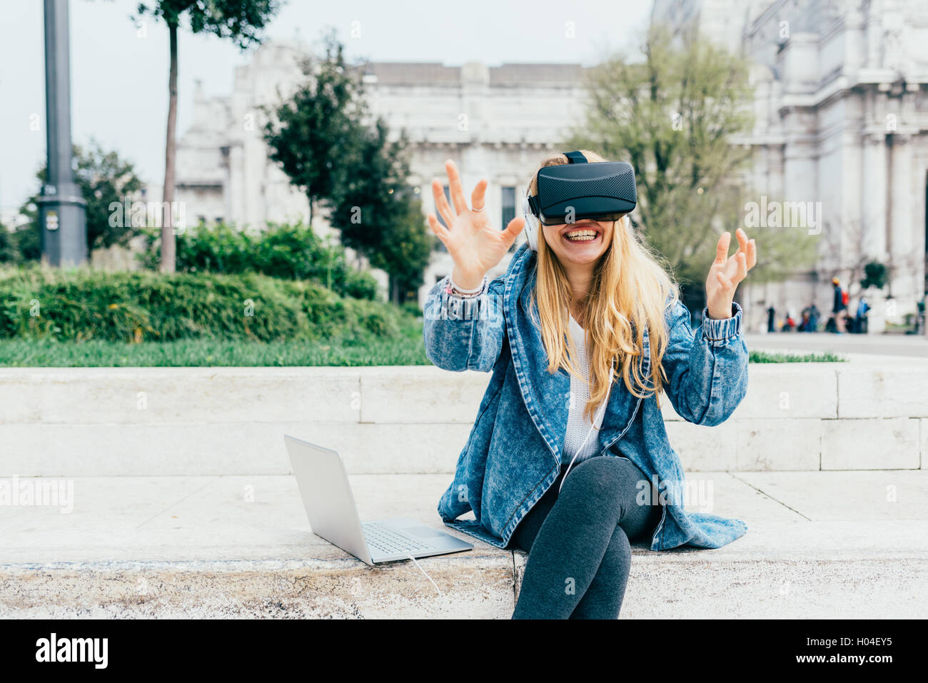 Young beautiful blonde caucasian business woman sitting using 3D viewer ...