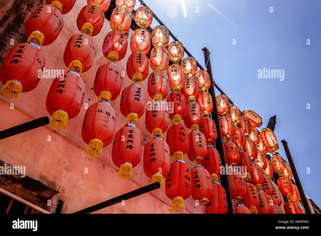 Hanging Chinese lanterns glowing in sunlight at Chinese temple in ...
