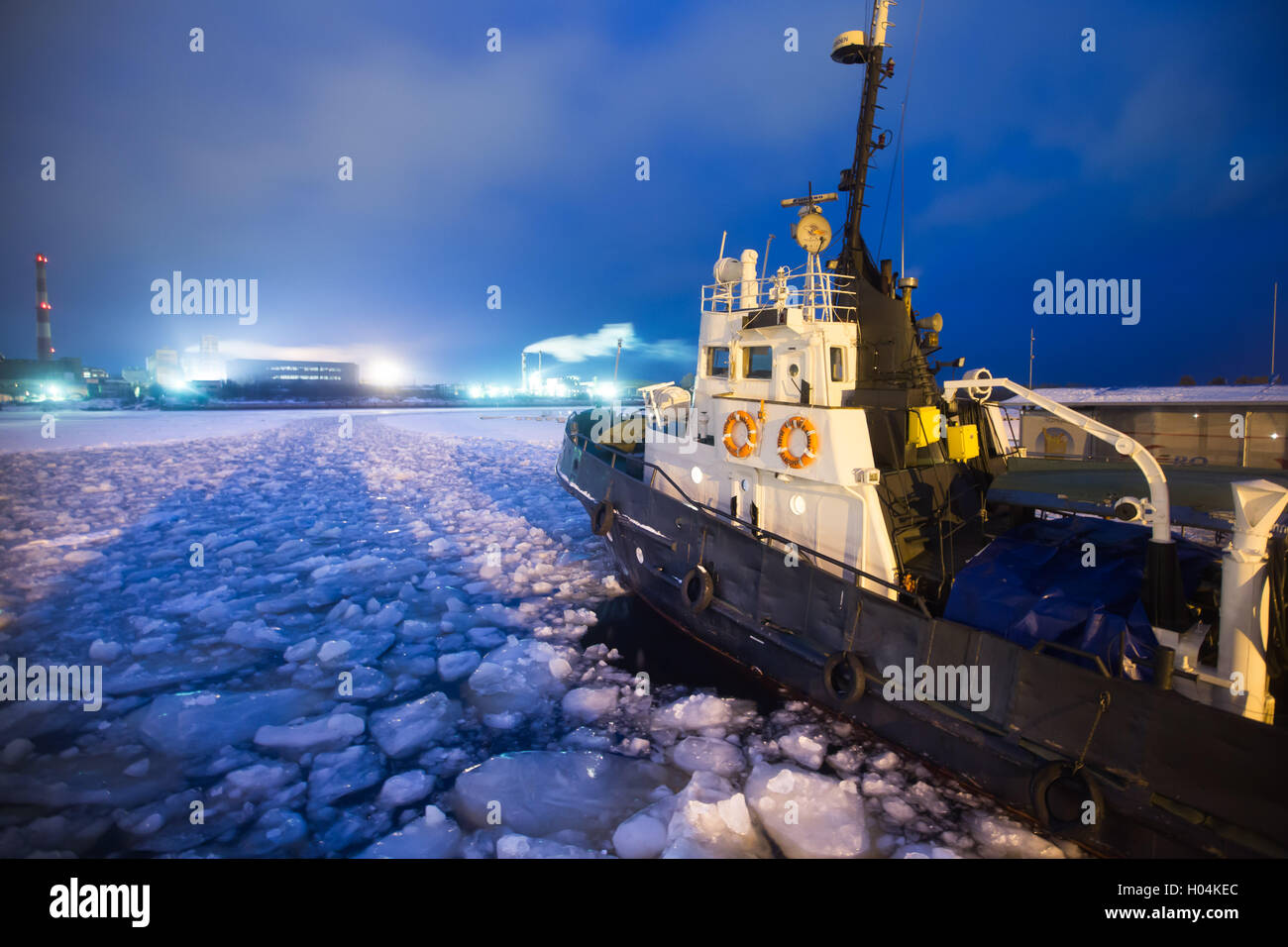 The Icebreaker ship trapped in ice tries to break and leave the bay ...