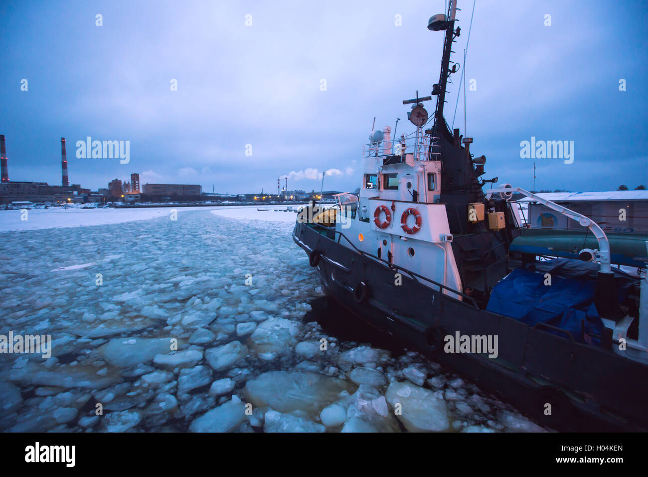 The Icebreaker ship trapped in ice tries to break and leave the bay ...