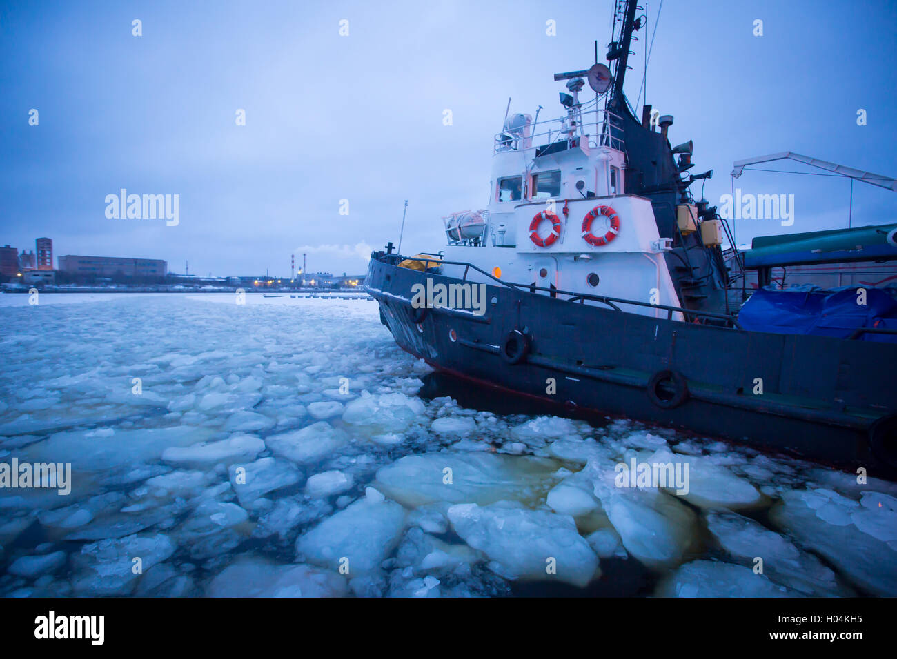 The Icebreaker ship trapped in ice tries to break and leave the bay ...