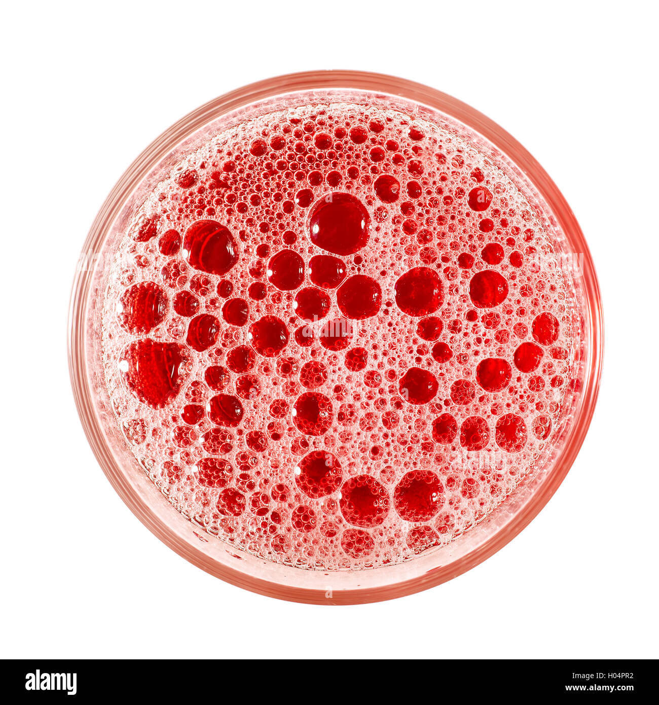 Top view of red frothy drink with foam and bubbles in simple glass ...