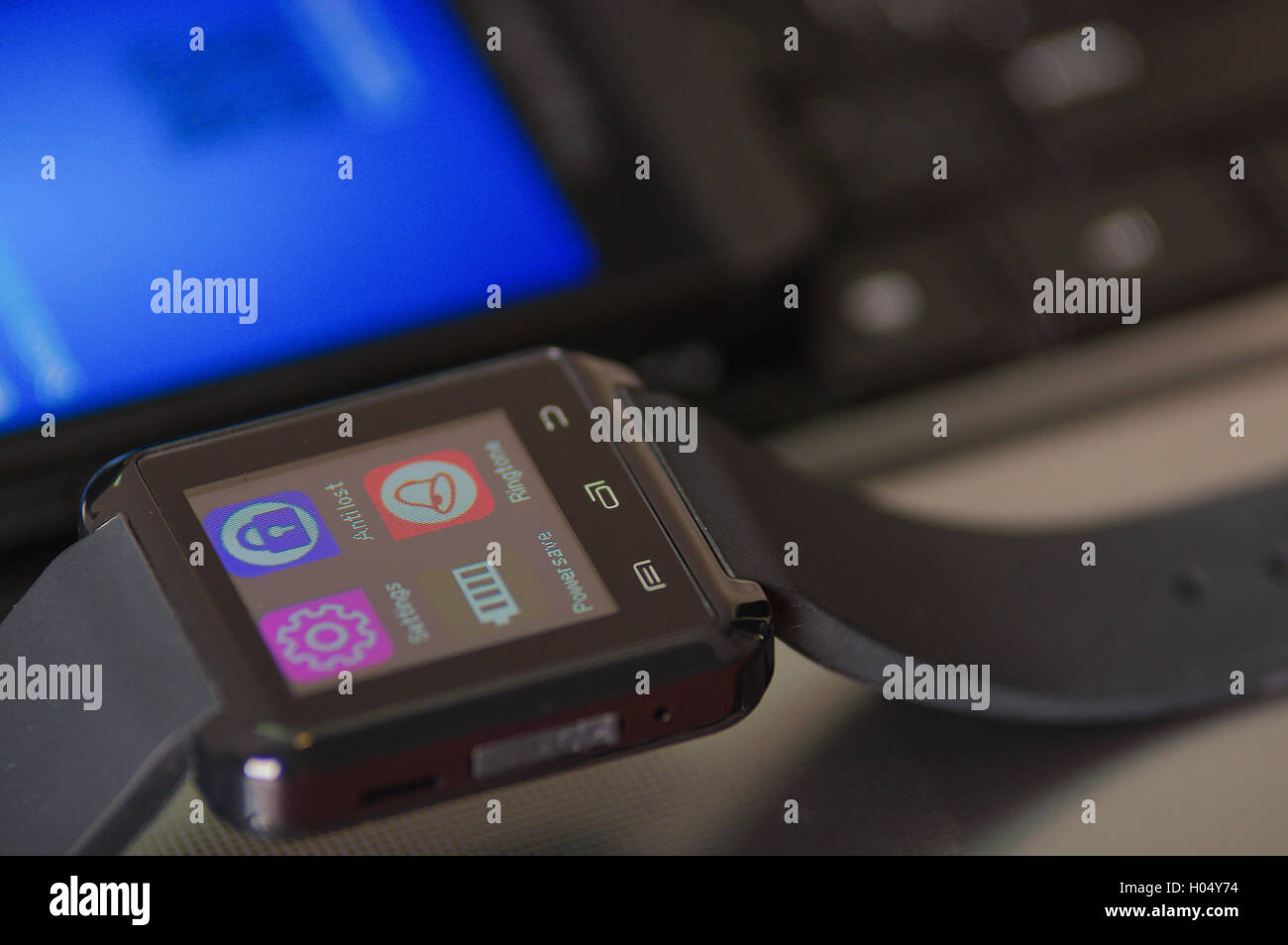 Smartwatch with screen lit up sitting on top of computer keyboard, very ...