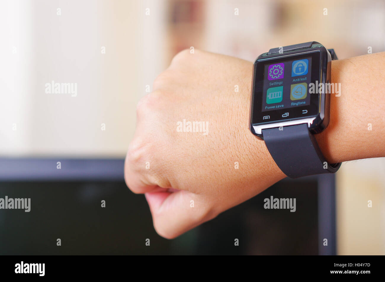 Closeup arm wrist wearing smart watch, screen lit up, using other hand ...