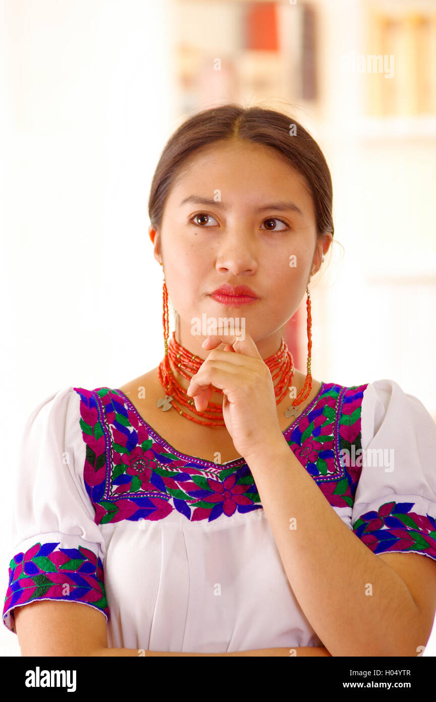 Beautiful young brunette woman wearing traditional andean white blouse ...