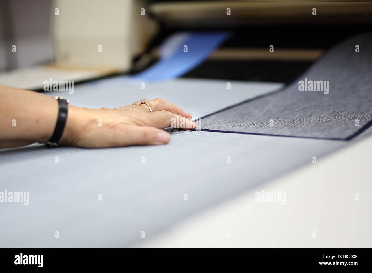 Lagging machine. Sewing worker lags material Work in sewing Stock Photo ...