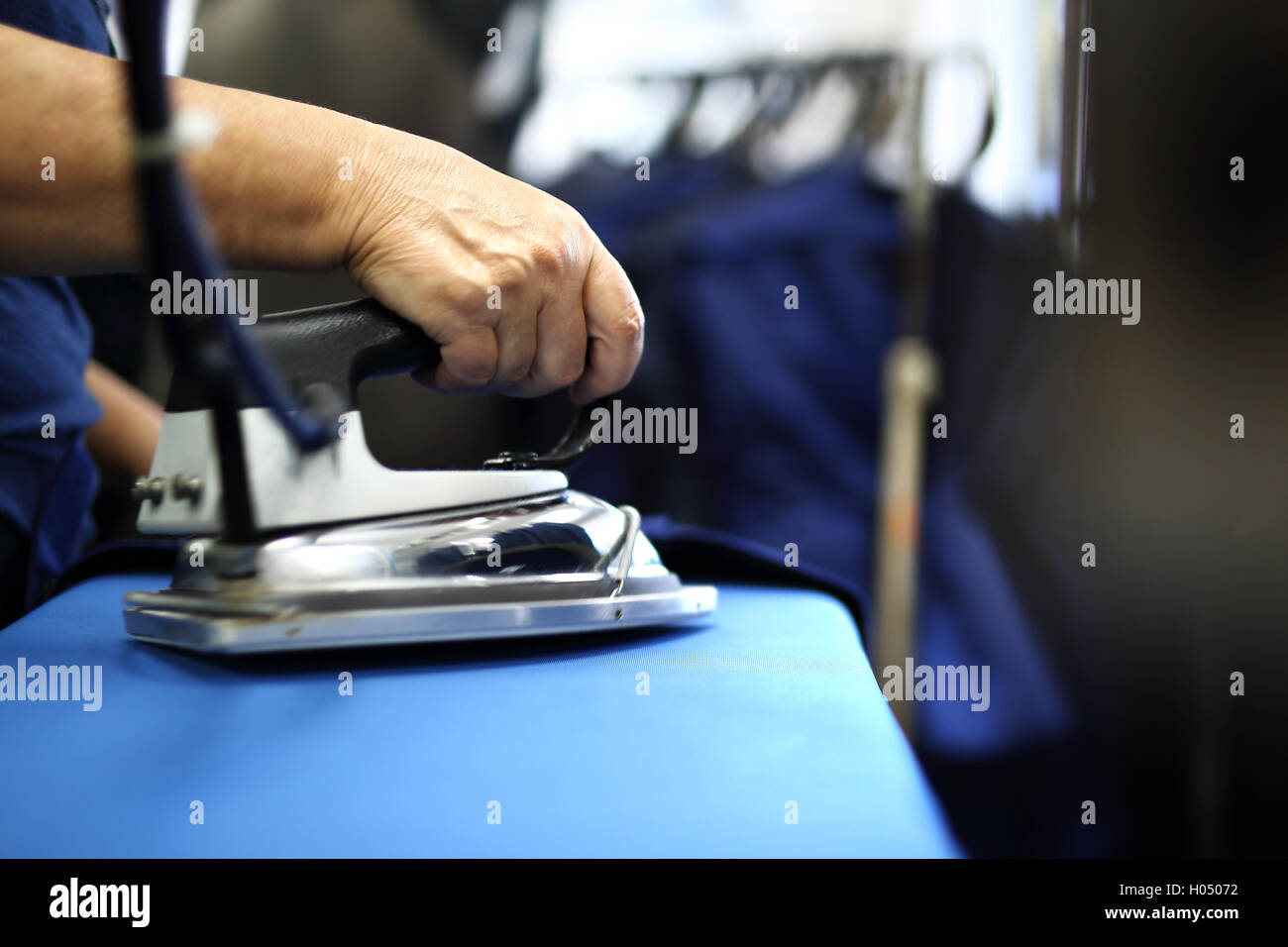 Woman irons in clothing factory hi-res stock photography and images - Alamy