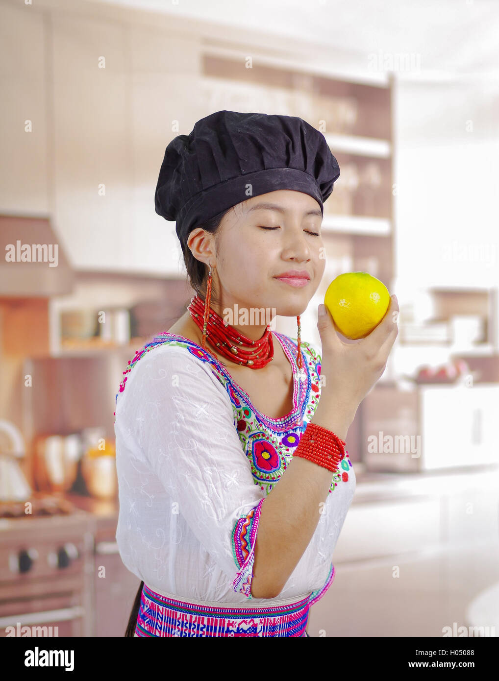 Young woman chef wearing traditional andean blouse, black cooking hat ...