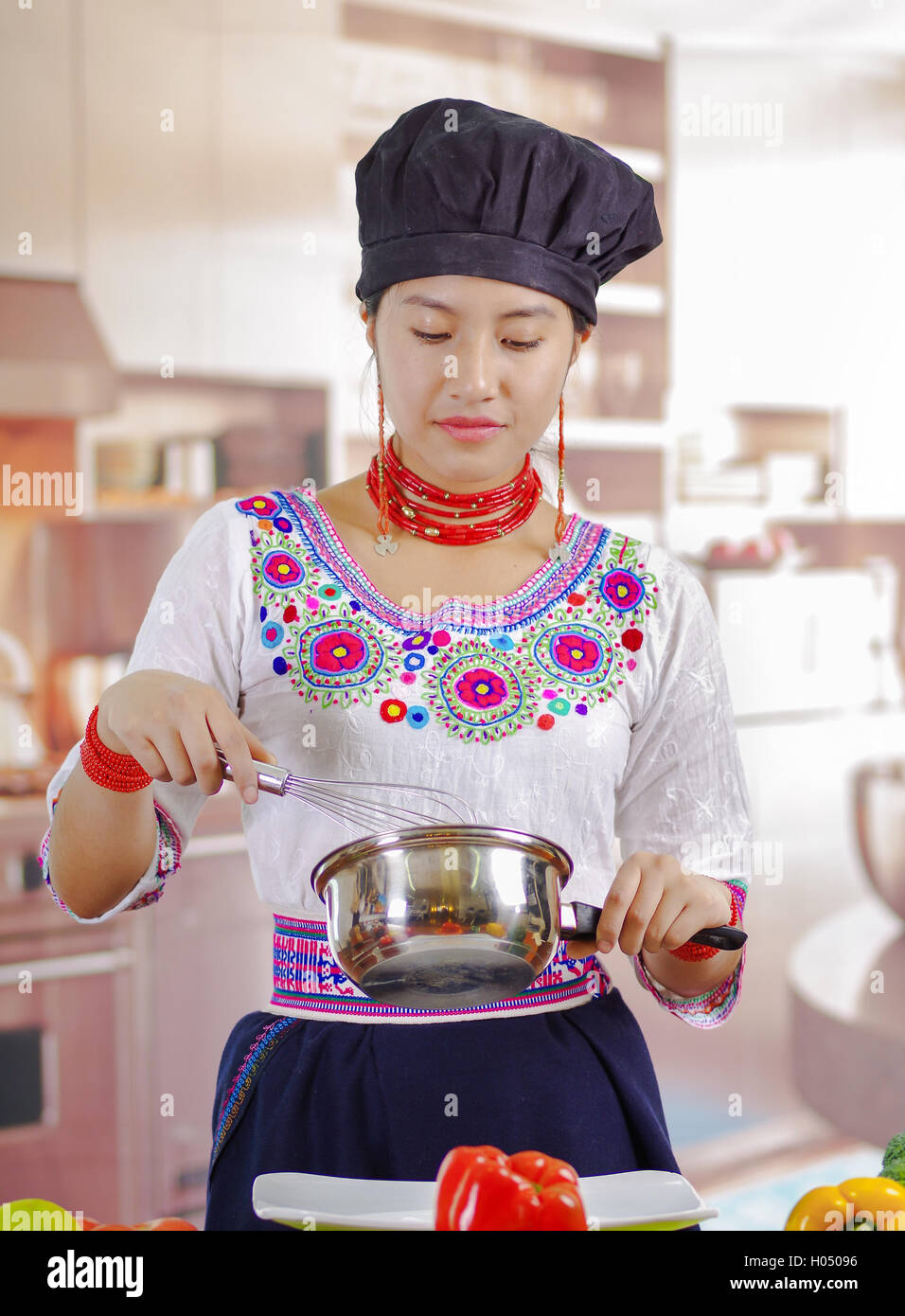 Young woman chef wearing traditional andean blouse and cooking hat ...