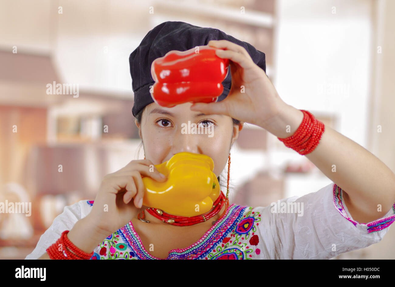 Young woman chef wearing traditional andean blouse, black cooking hat ...