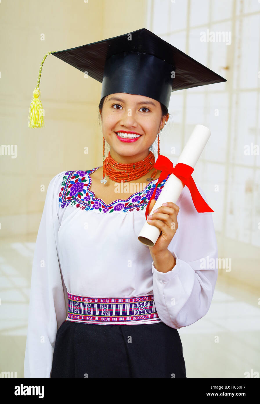 Young female student wearing traditional blouse and graduation hat ...