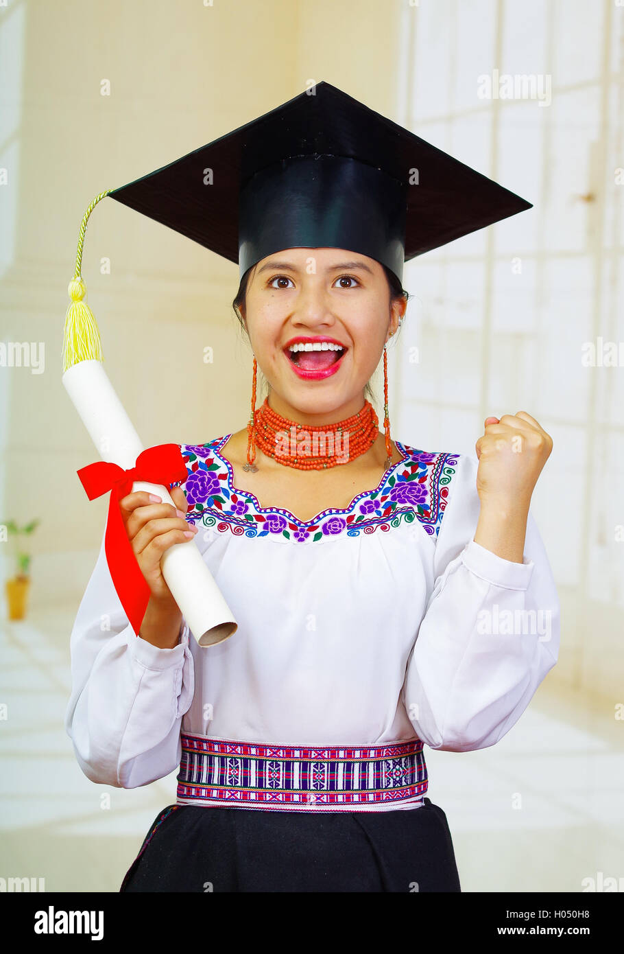 Young female student wearing traditional blouse and graduation hat ...