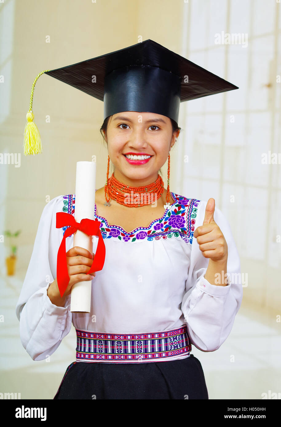 Young female student wearing traditional blouse and graduation hat ...