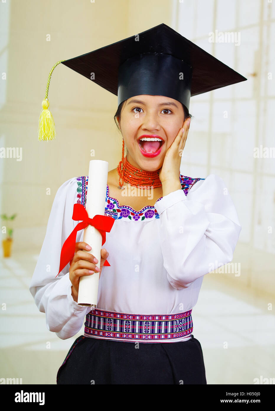 Young female student wearing traditional blouse and graduation hat ...