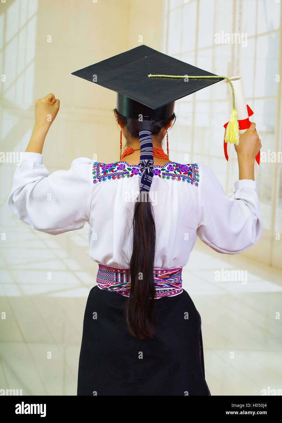 Young female student wearing traditional blouse and graduation hat ...