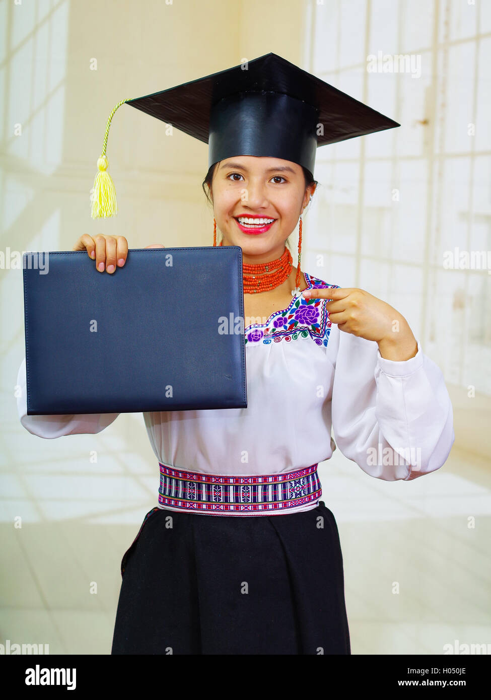 Young female student wearing traditional blouse and graduation hat ...