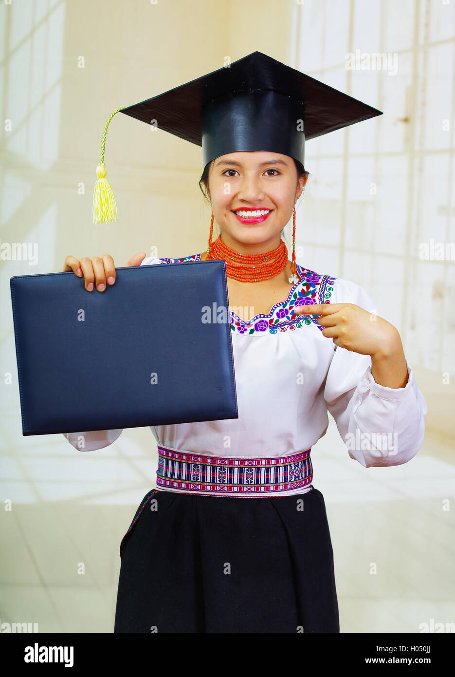 Young female student wearing traditional blouse and graduation hat ...