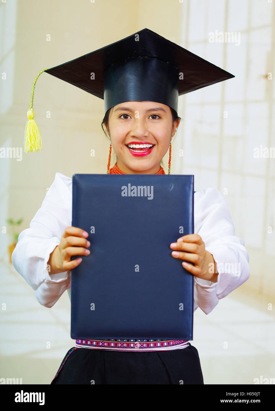 Young female student wearing traditional blouse and graduation hat ...