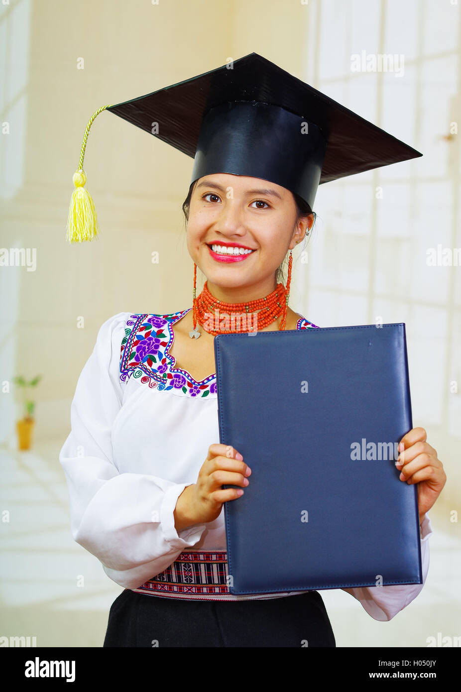 Young female student wearing traditional blouse and graduation hat ...