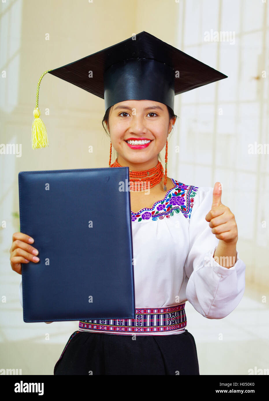 Young female student wearing traditional blouse and graduation hat ...